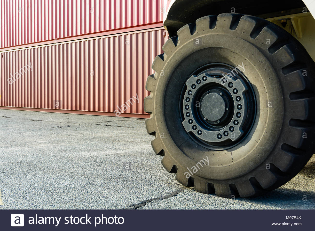 wheel-of-a-reach-stacker-and-stacked-containers-in-a-shipping-yard-in ...